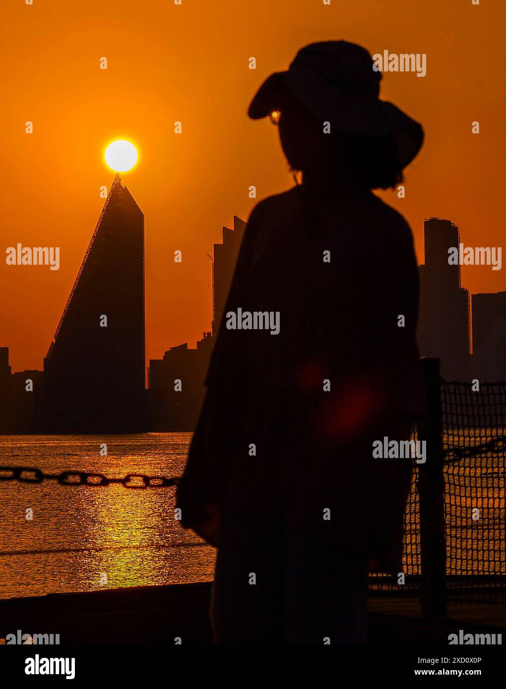 QATAR WEATHER 2024 People enjoy the sunset with the Doha skyline as ...
