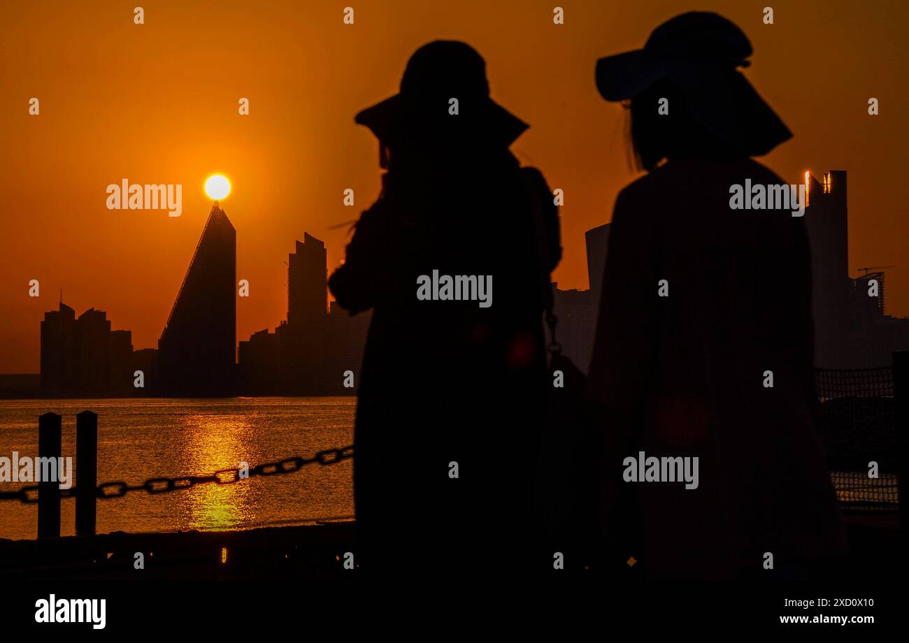QATAR WEATHER 2024 People enjoy the sunset with the Doha skyline as ...