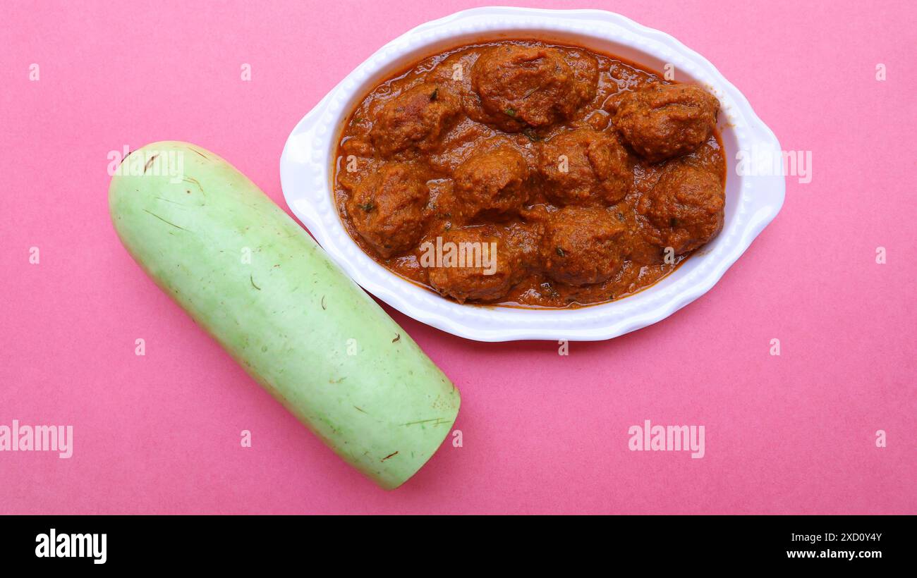 Delicious Lauki ke kofte or Loki kofta dunked in masala gravy in dish ...