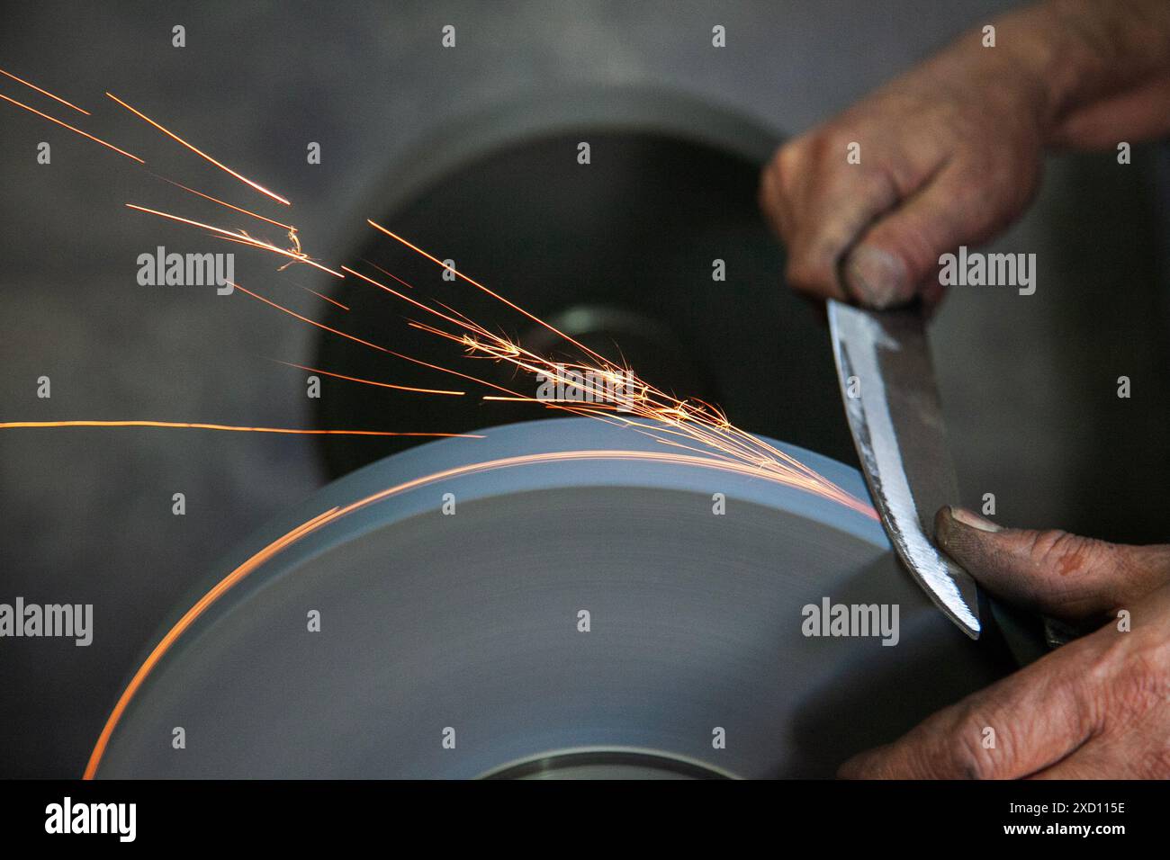 Knife sharpener and hand with blade on table, closeup Stock Photo - Alamy