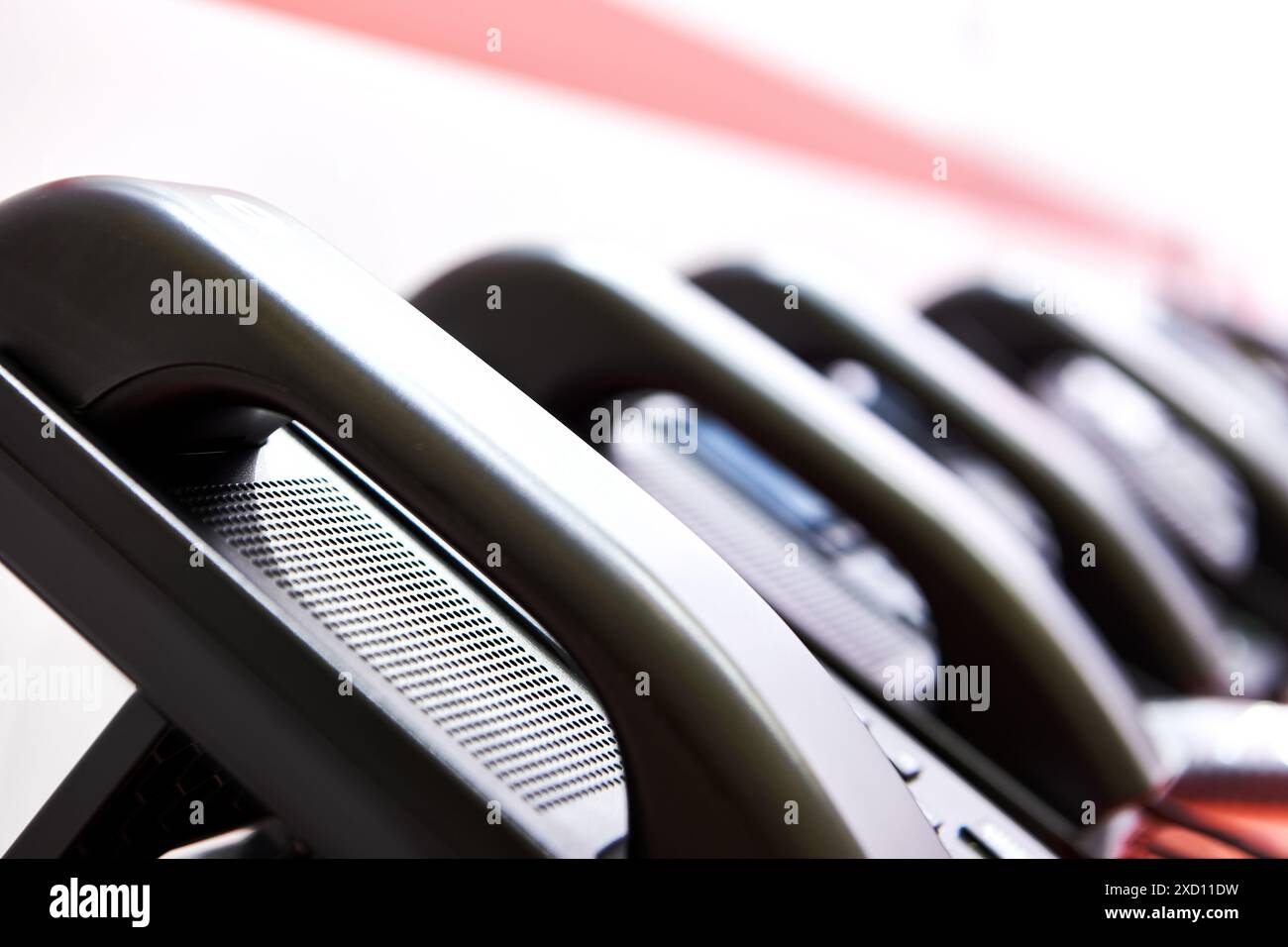 Handsets of office phones row Stock Photo - Alamy