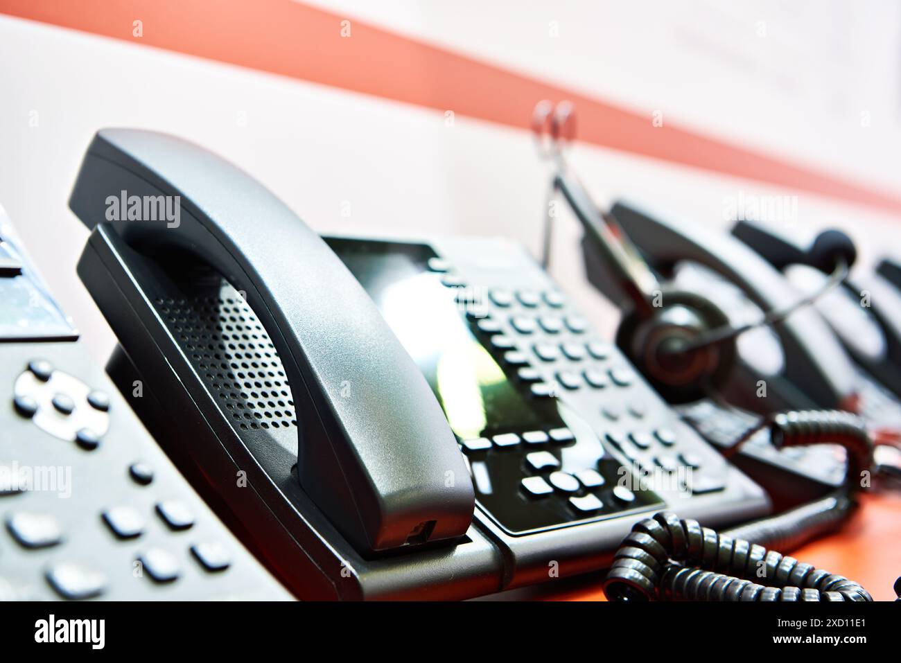 Handsets of office phones row Stock Photo - Alamy