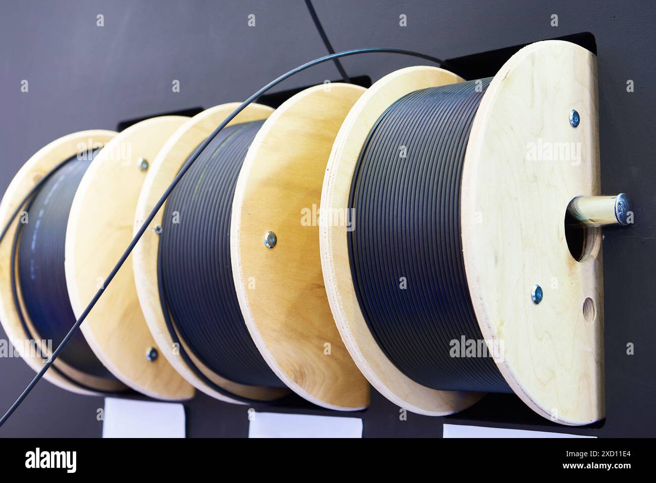 Wooden spools with cables in store Stock Photo - Alamy