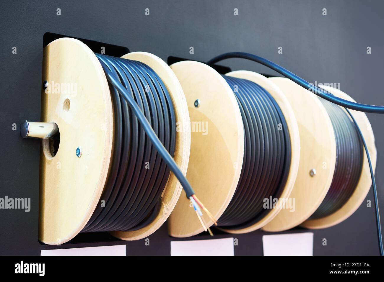 Wooden spools with cables in store Stock Photo - Alamy