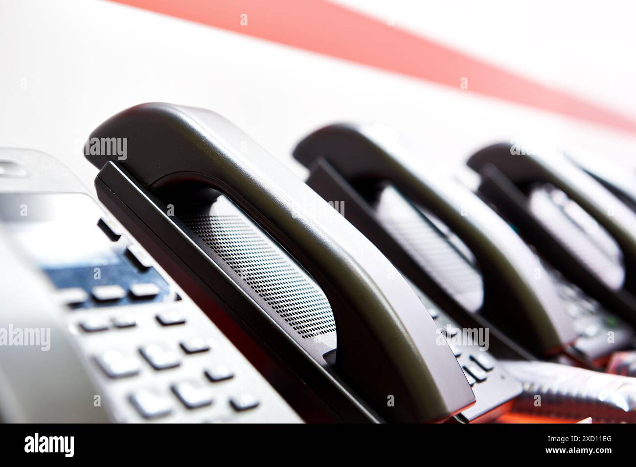 Handsets of office phones row Stock Photo - Alamy