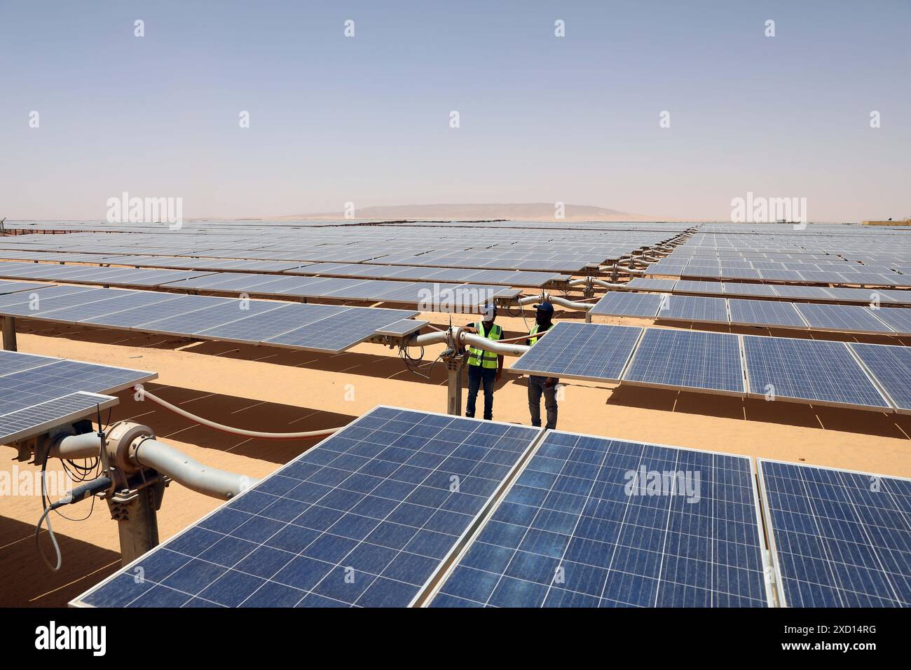 Two workers check solar panels hi-res stock photography and images - Alamy