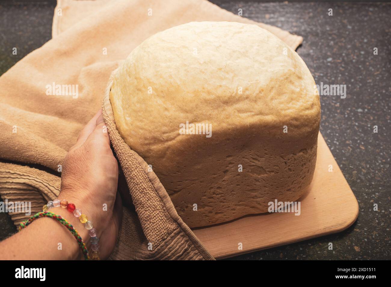 The hostess baked white bread in a bread machine and laid it out on a ...