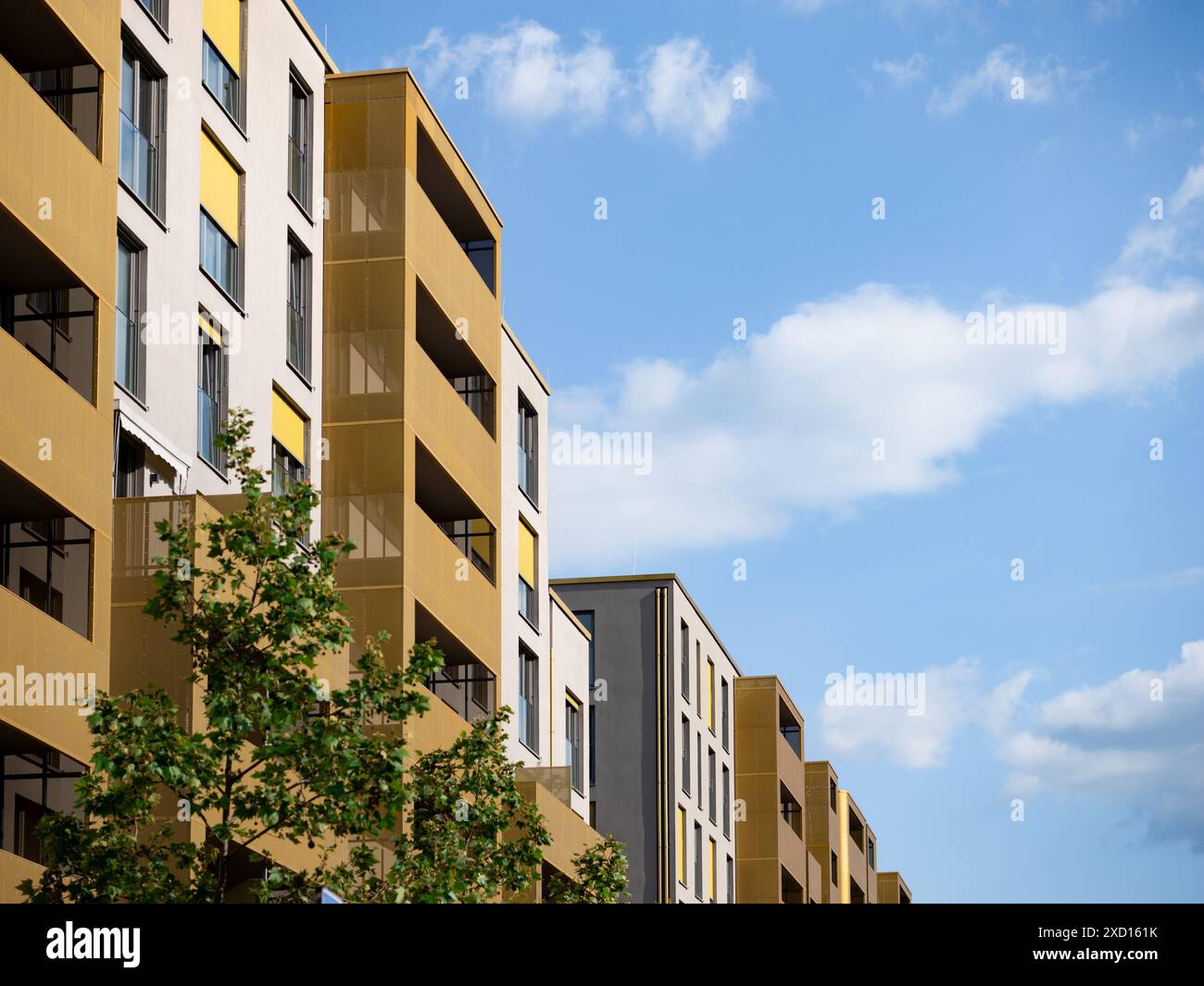 Modern residential building with yellow golden elements like the ...