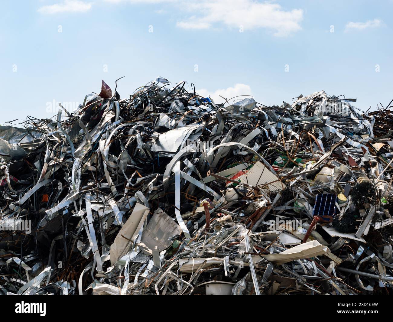 Scrap metal on a big heap in front of the sky. Huge pile of old metal ...