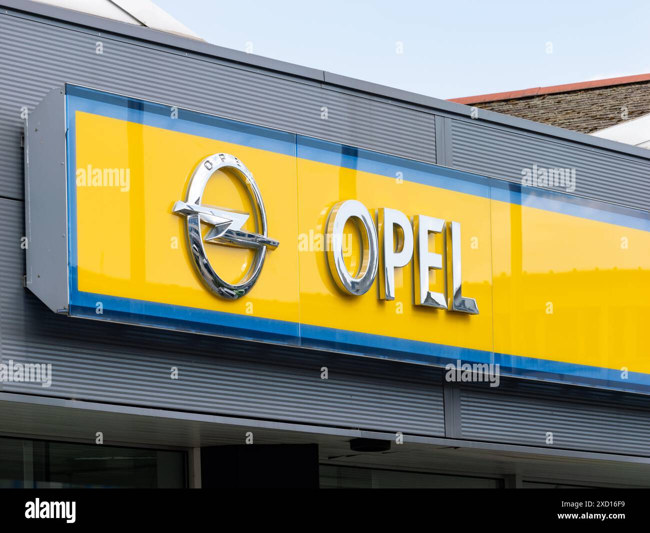Opel logo sign at a car dealer building. Emblem on a yellow background ...