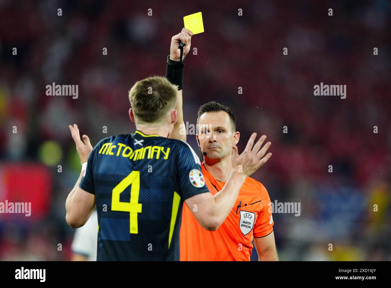 Scotland's Scott McTominay (left) is shown a yellow card by match ...
