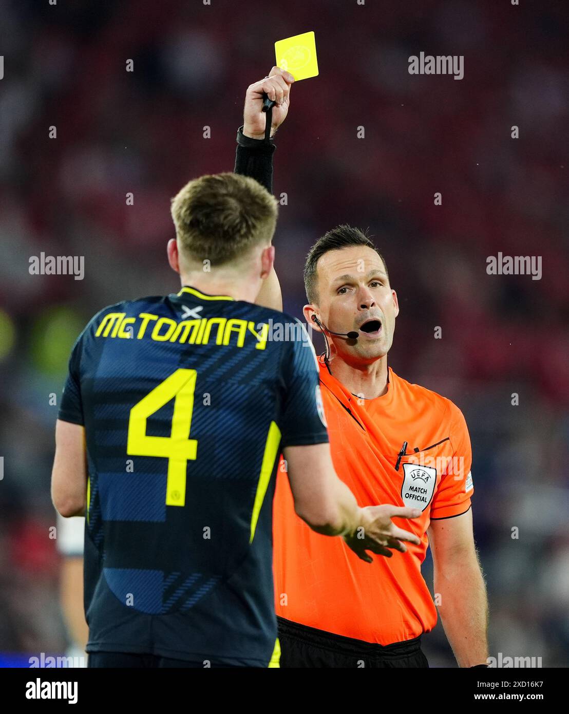 Scotland's Scott McTominay (left) is shown a yellow card by match ...