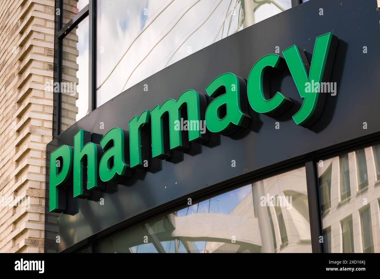 Pharmacy logo sign on a building facade. Drugstore advertisement in big ...