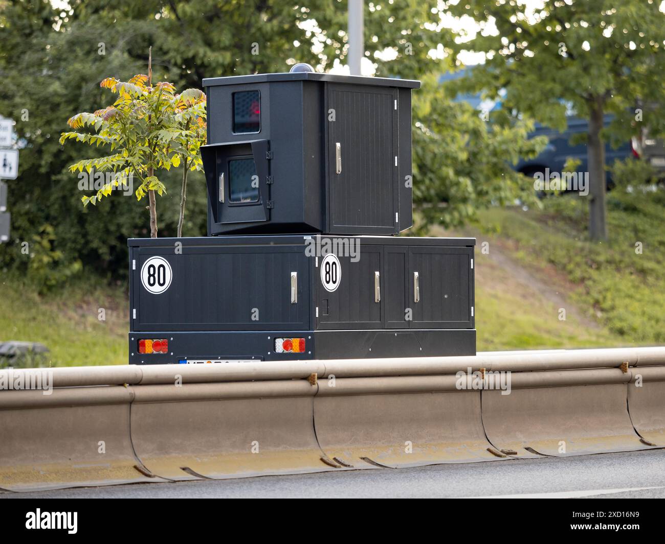 Speed camera on a trailer set up next to a big street. Technology to ...