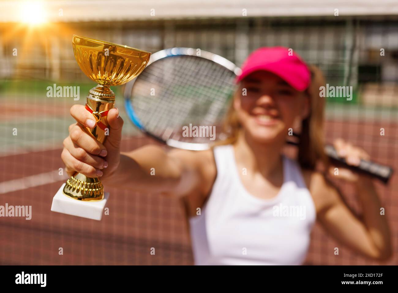 Excited young female tennis player celebrating victory on the card ...