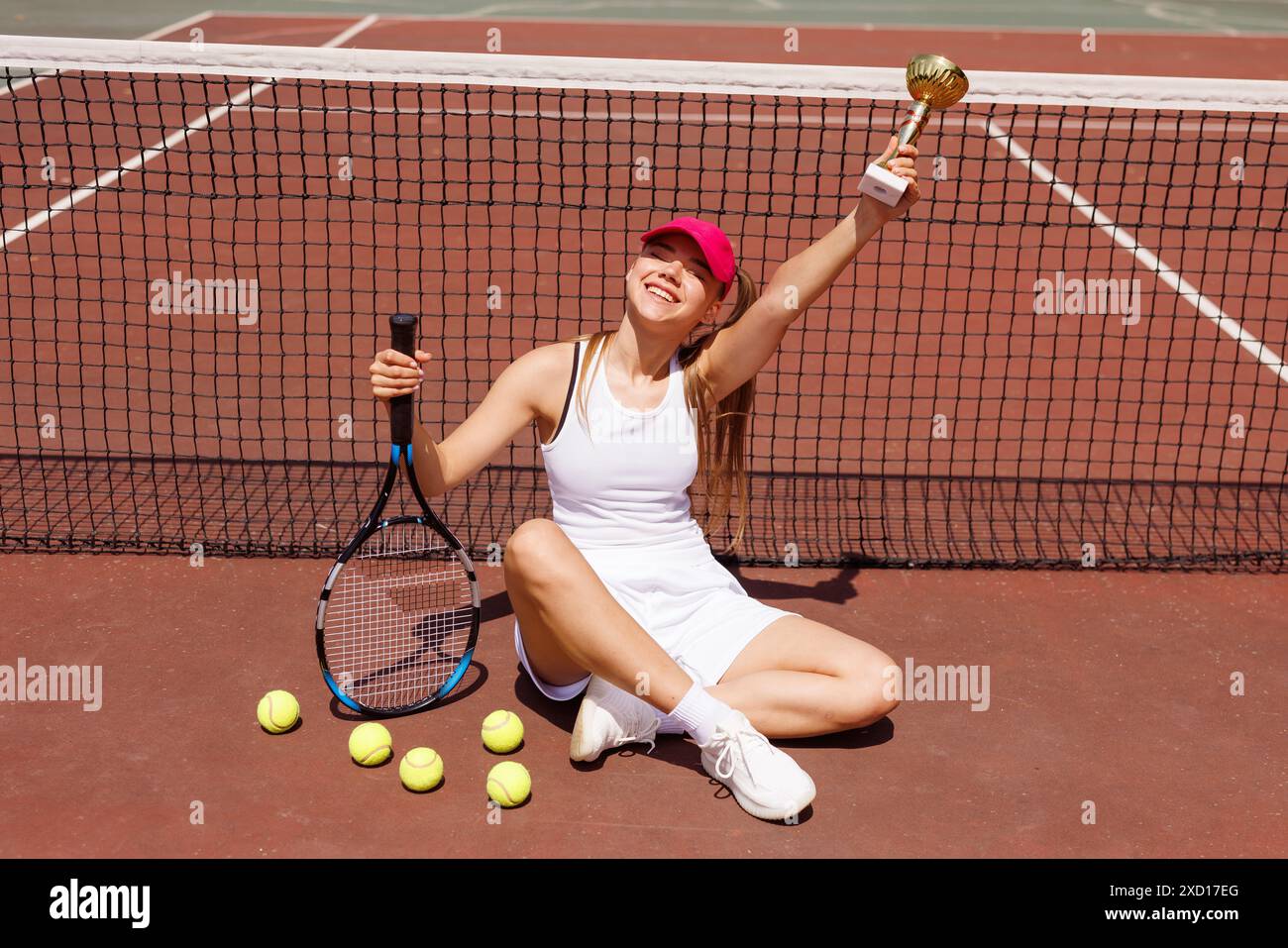 Excited young female tennis player celebrating victory on the card ...