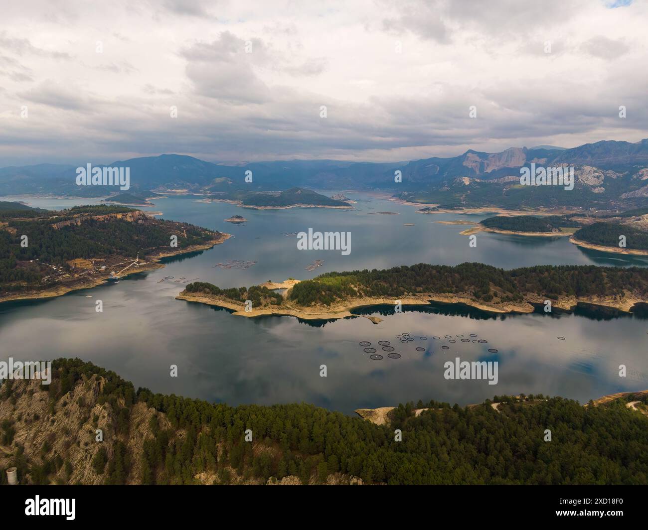 A dam lake in Turkey surrounded by forests. Fish cages in the lake ...