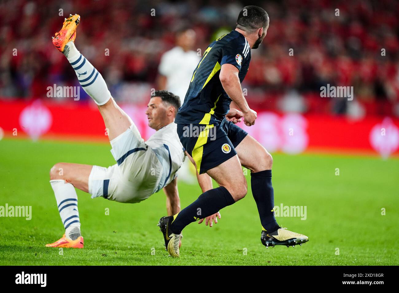 Switzerland's Fabian Schar is fouled by Scotland's John McGinn (right ...
