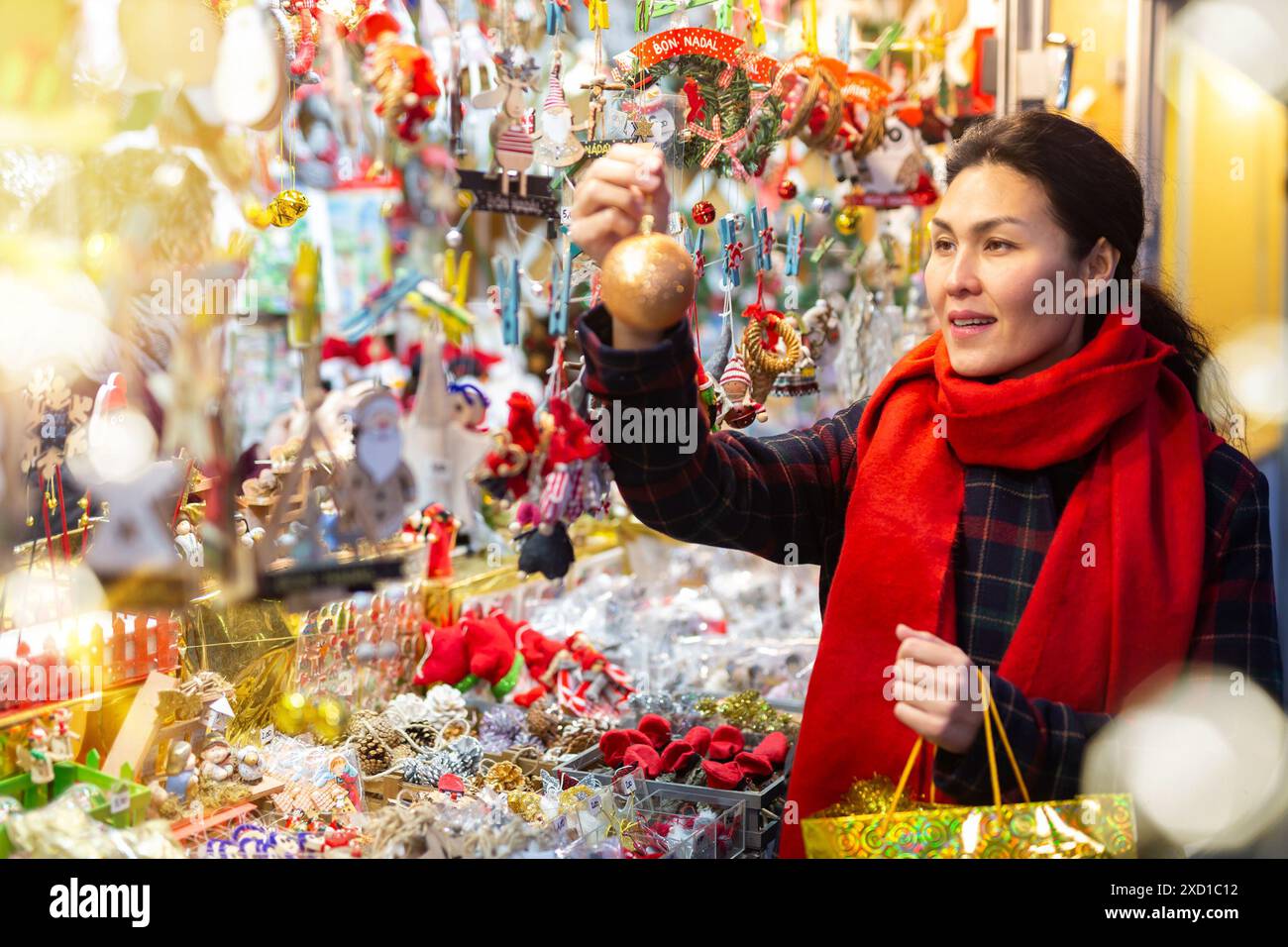 Asian female choosing decorations at Christmas fair Stock Photo - Alamy