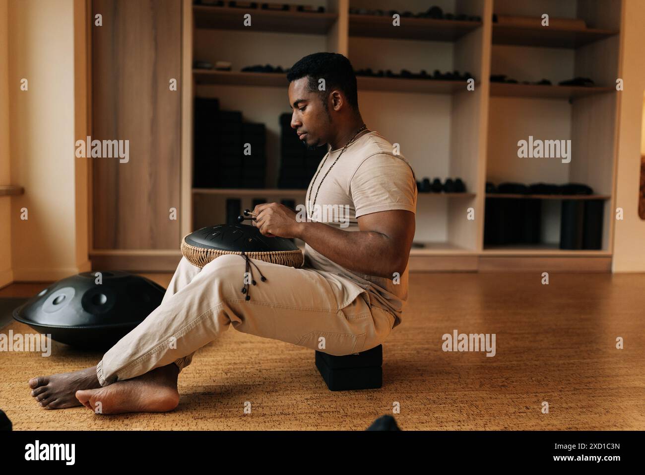 Side view of calm African-African man in trance playing meditative ...