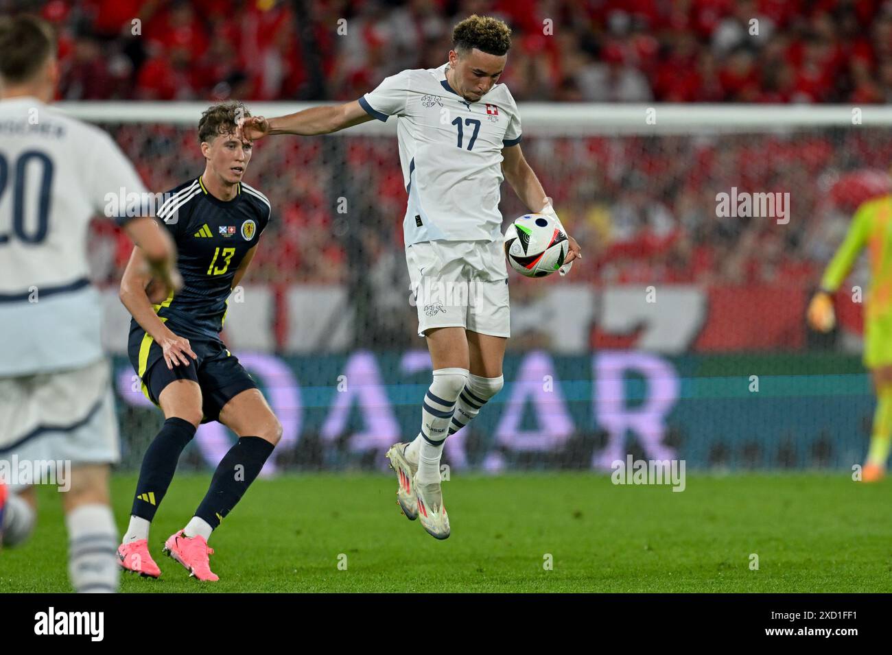 Jack Hendry (13) of Scotland defending on Ruben Vargas (17) of ...