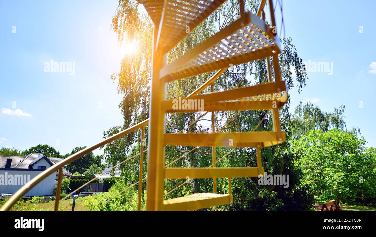 Winding spiral staircase outdoors. Metal curved stairs. Circular ...