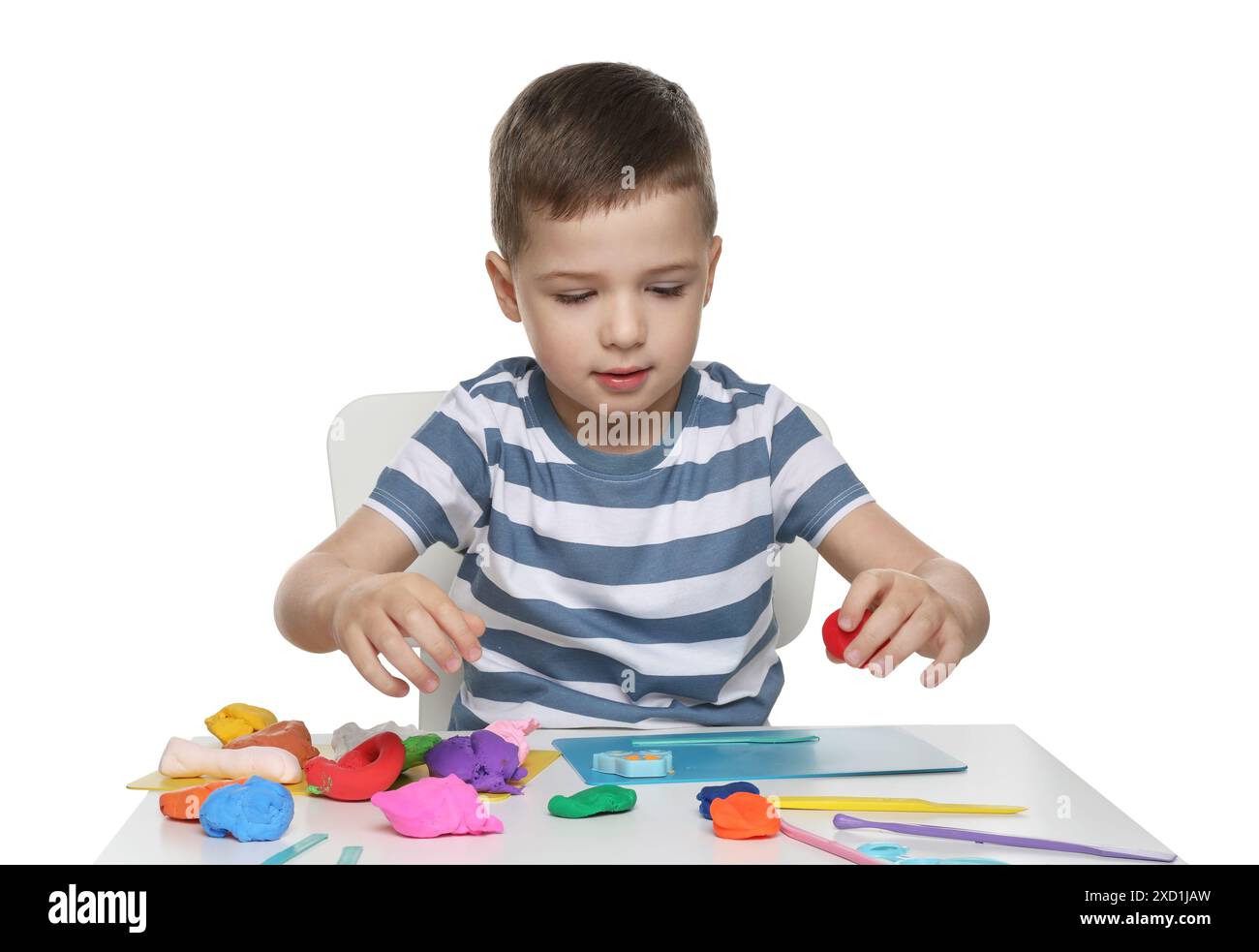 Little boy sculpting with play dough at table on white background Stock ...