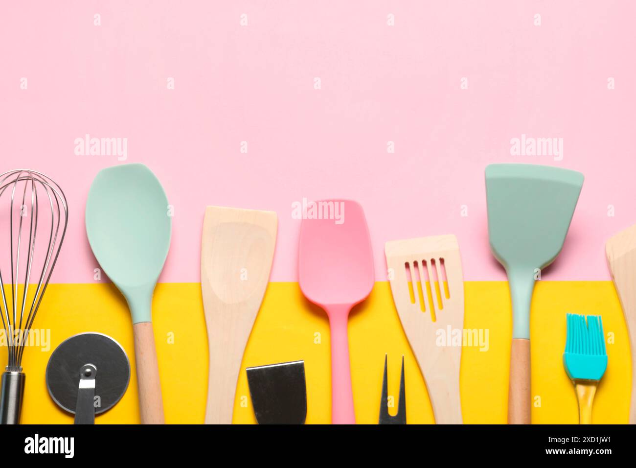 Different spatulas and other kitchen utensils on color background, flat ...