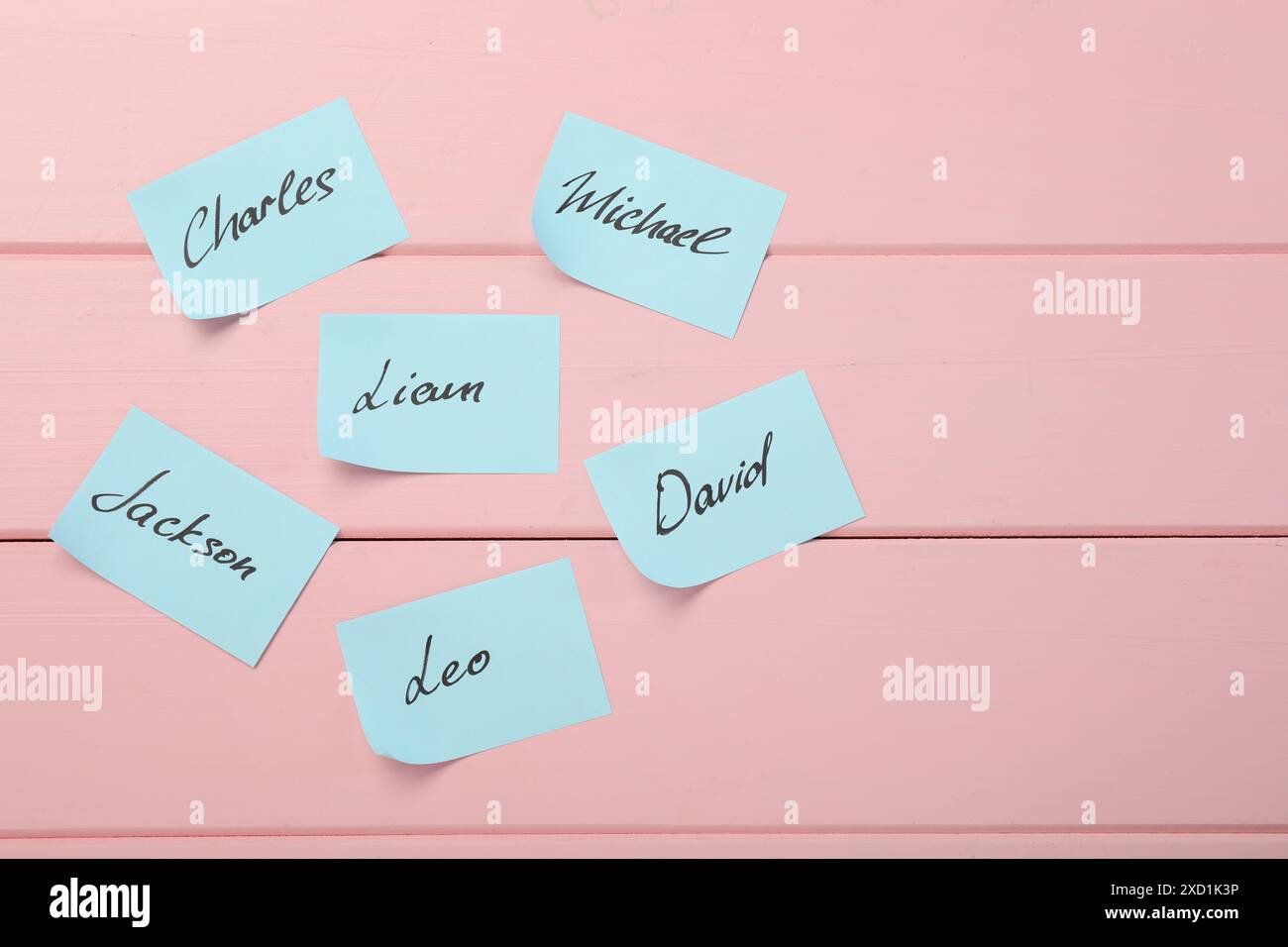 Choosing baby's name. Paper stickers with different names on pink ...