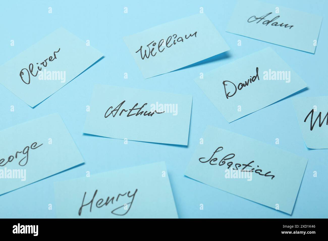 Choosing baby name. Paper stickers with different names on light blue ...