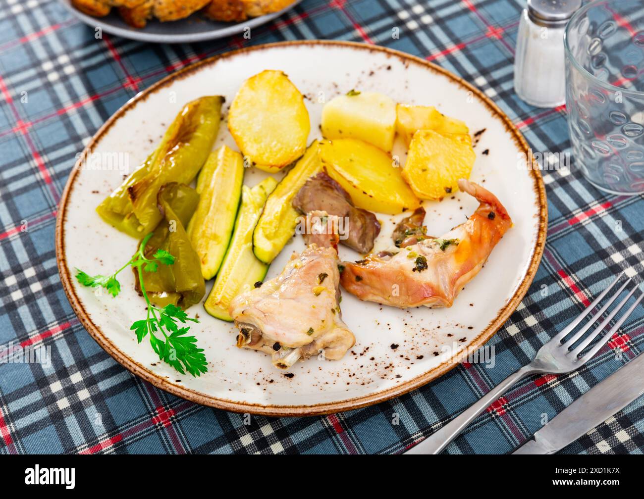 Roasted rabbit served with vegetable garnish Stock Photo - Alamy