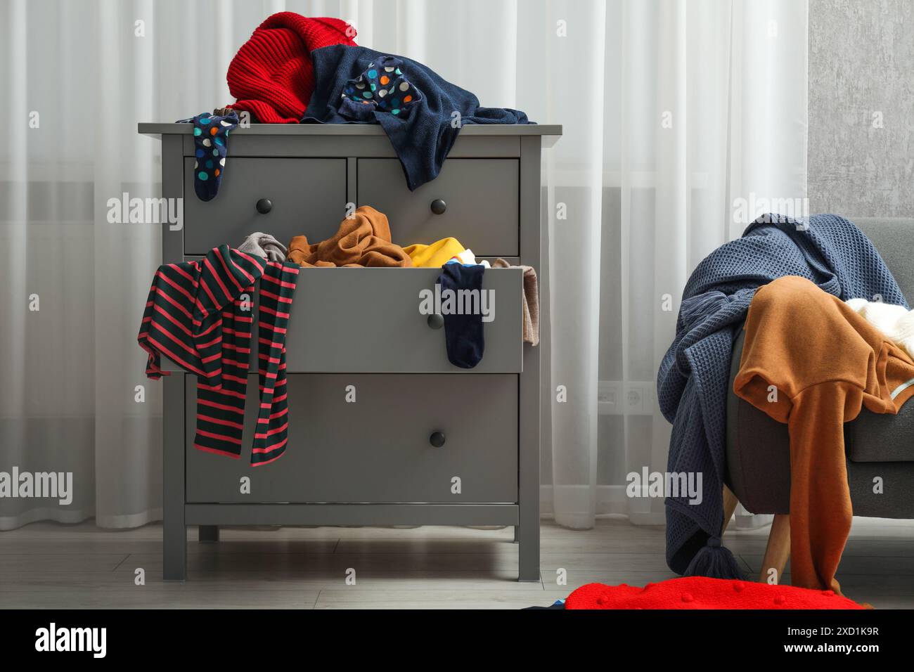 Room and dresser cluttered with clothes. Messy house Stock Photo - Alamy