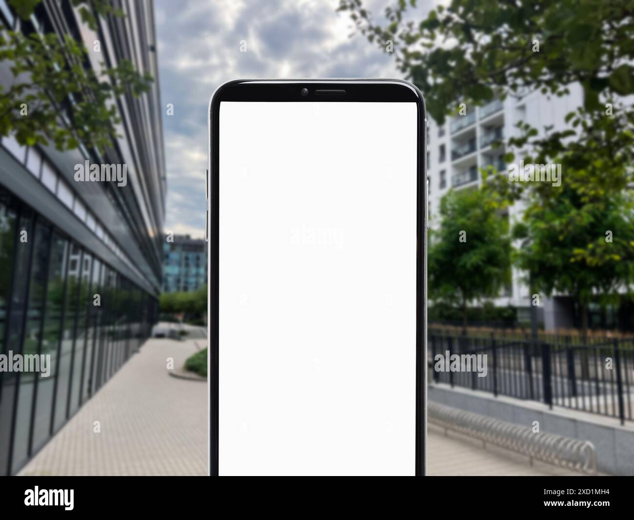 Mobile phone with empty screen against city street. Space for design ...
