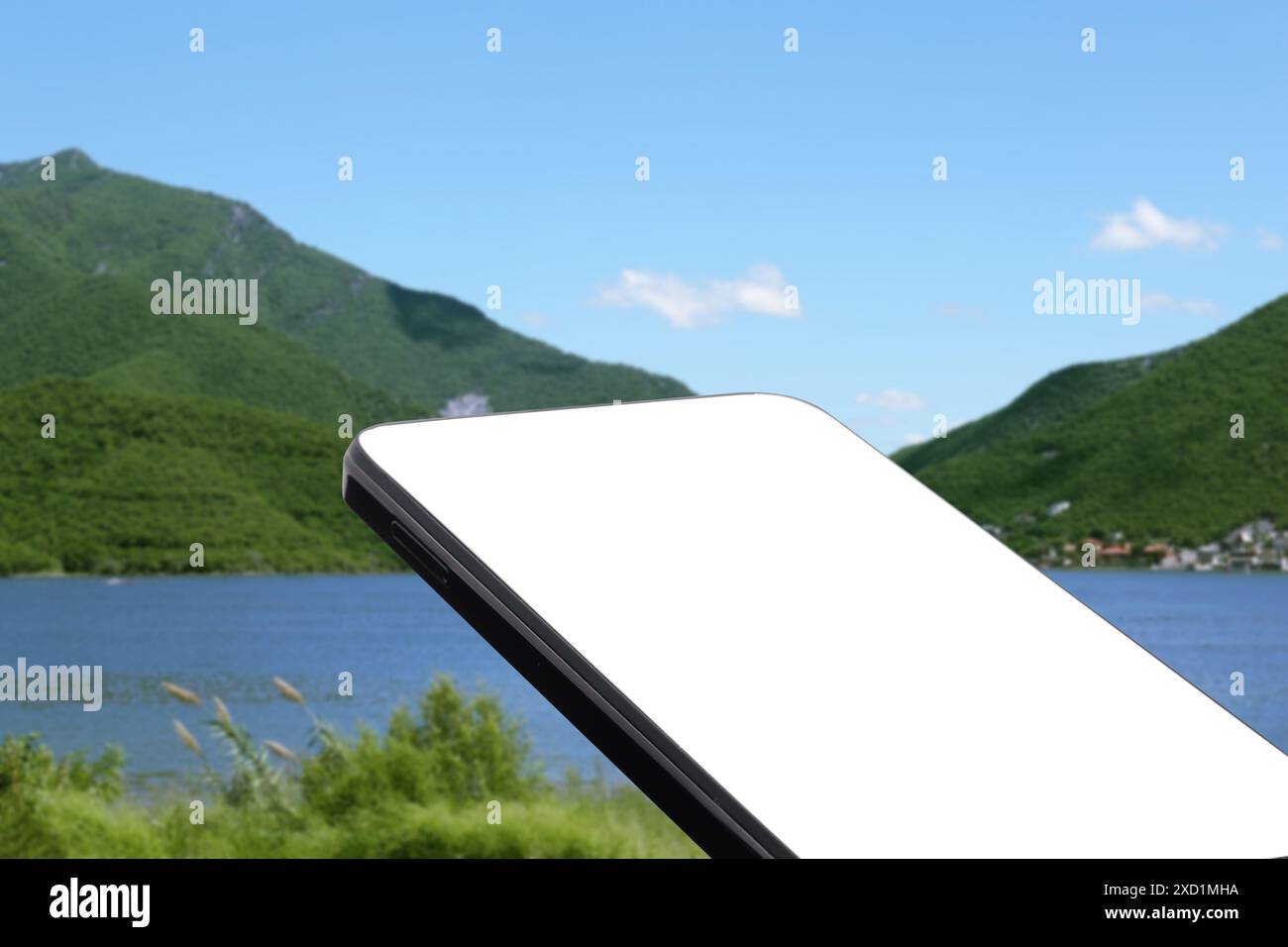 Mobile phone with empty screen against beautiful landscape. Space for ...