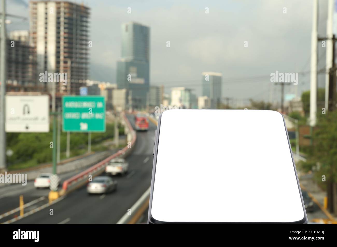 Mobile phone with empty screen against city view. Space for design ...