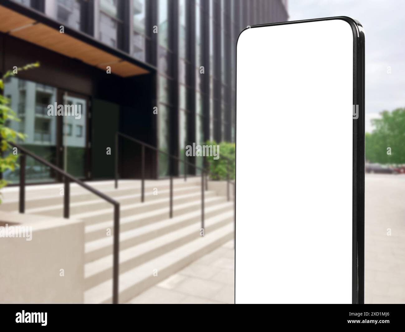 Mobile phone with empty screen against office building. Space for ...
