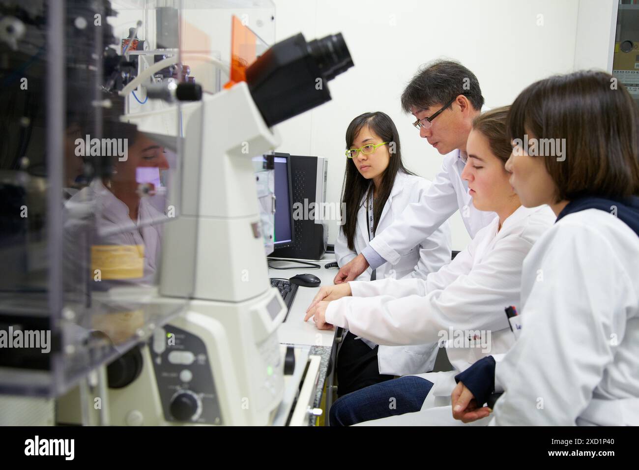 Students men working on microscope hi-res stock photography and images ...