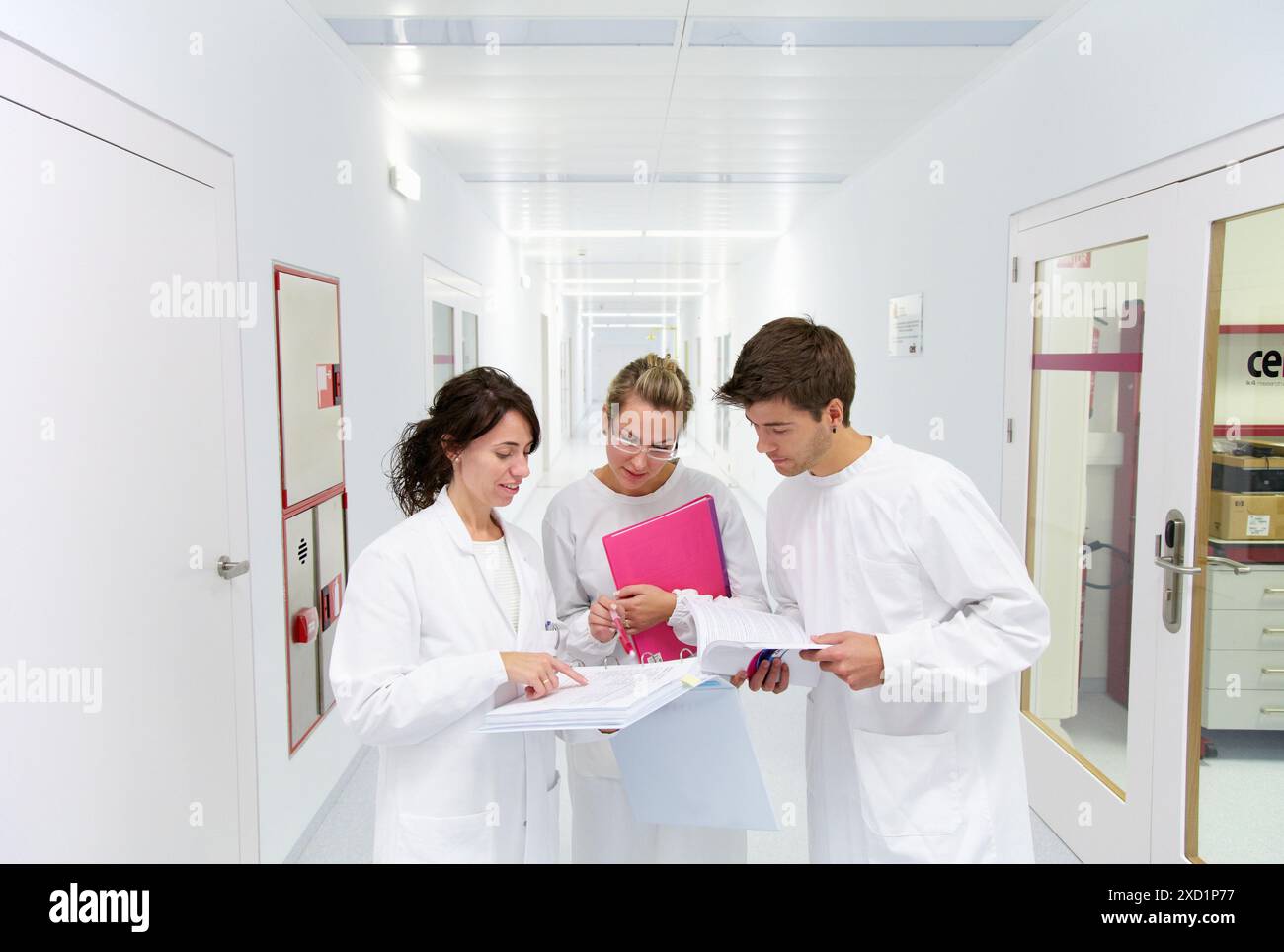 Teacher and students in hallway BioMEMS laboratory Research of surface chemistry and biological ...