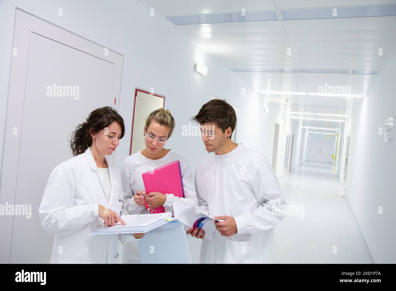 Teacher and students in hallway BioMEMS laboratory Research of surface chemistry and biological ...