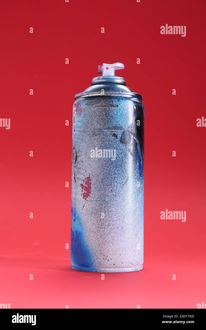 One can of bright spray paint on red background Stock Photo - Alamy