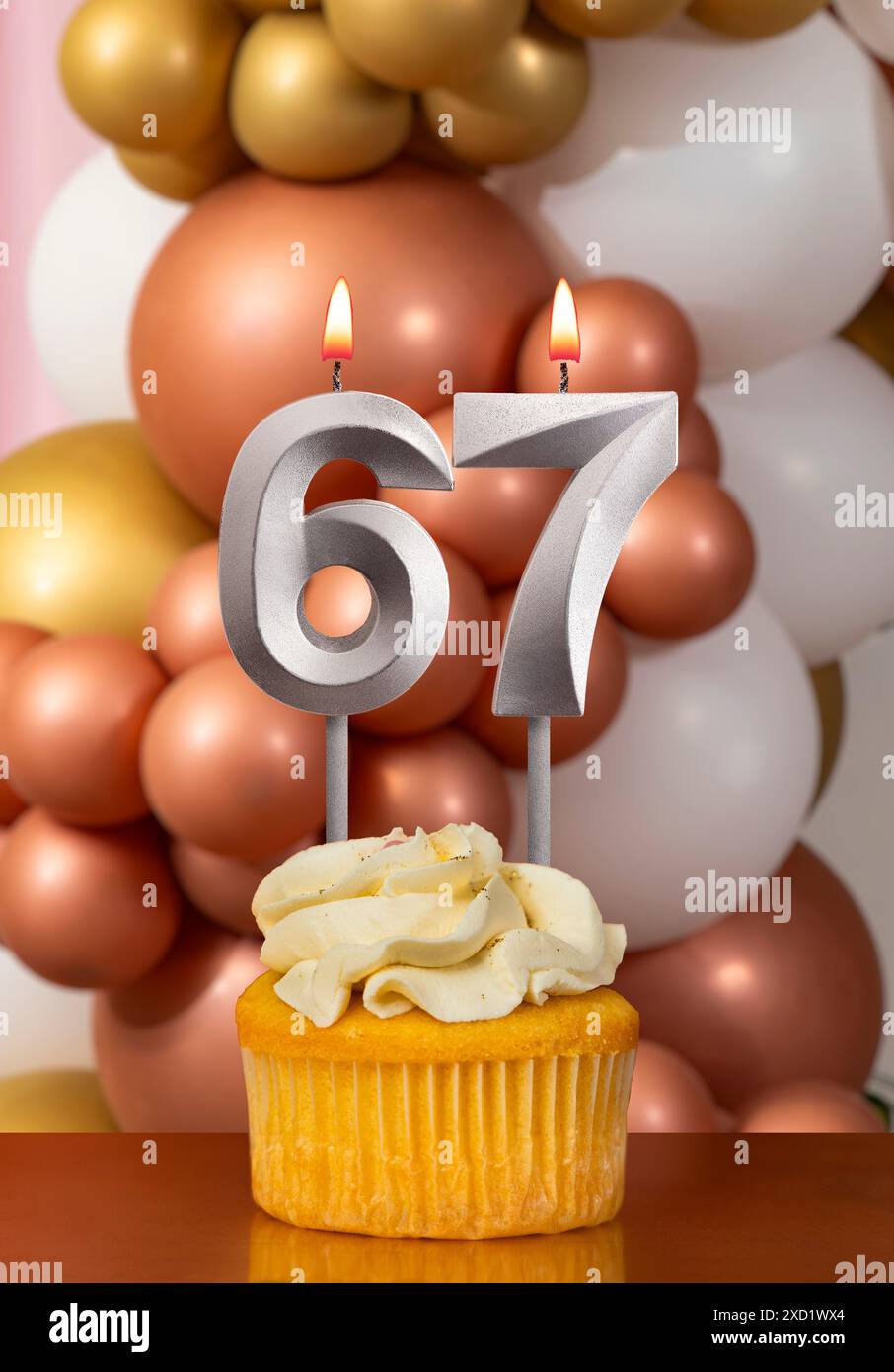 Cupcake with birthday candle on balloons background - Number 67 Stock ...