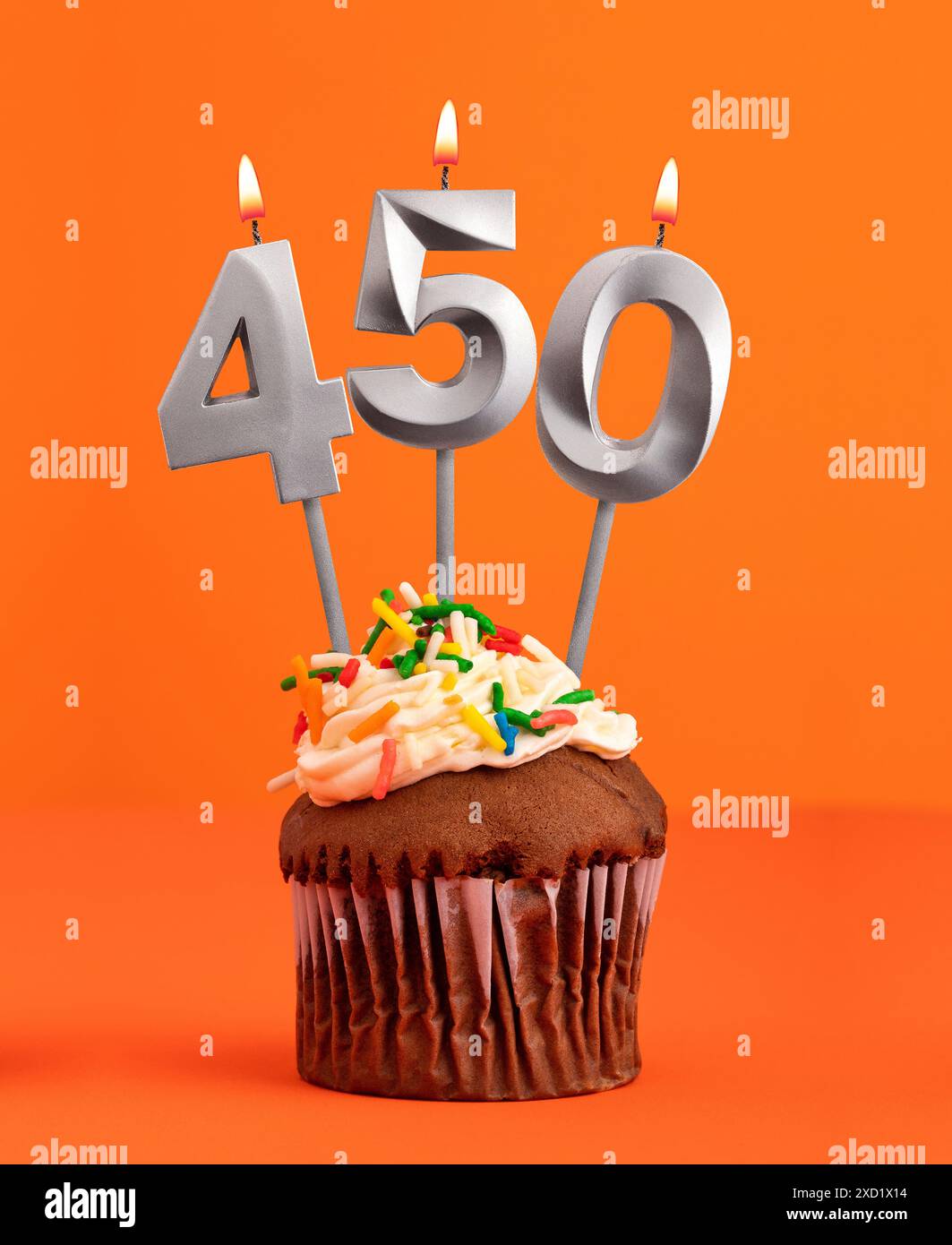 Birthday cupcake with number 450 candle - Orange color background Stock ...