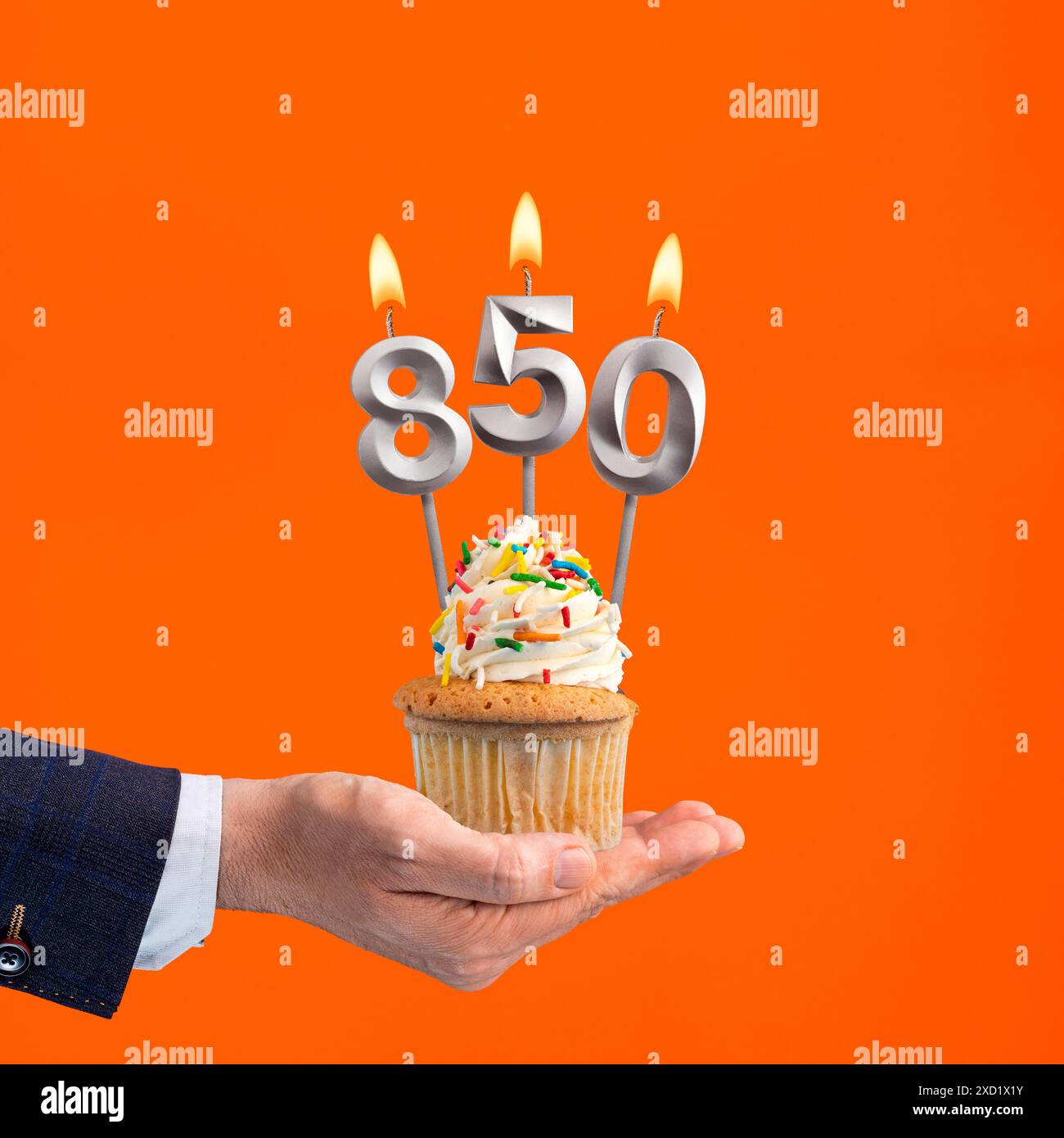 The hand that delivers cupcake with the number 850 candle - Birthday on ...