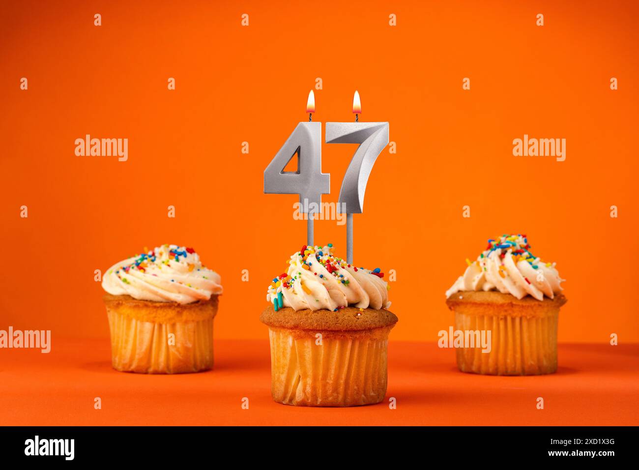 Candle number 47 - Celebration with birthday cupcake on orange ...