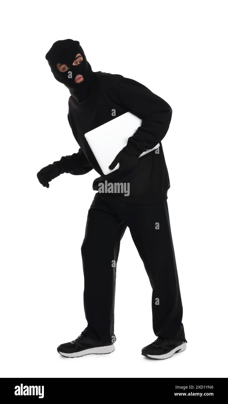 Thief in balaclava sneaking with laptop on white background Stock Photo ...