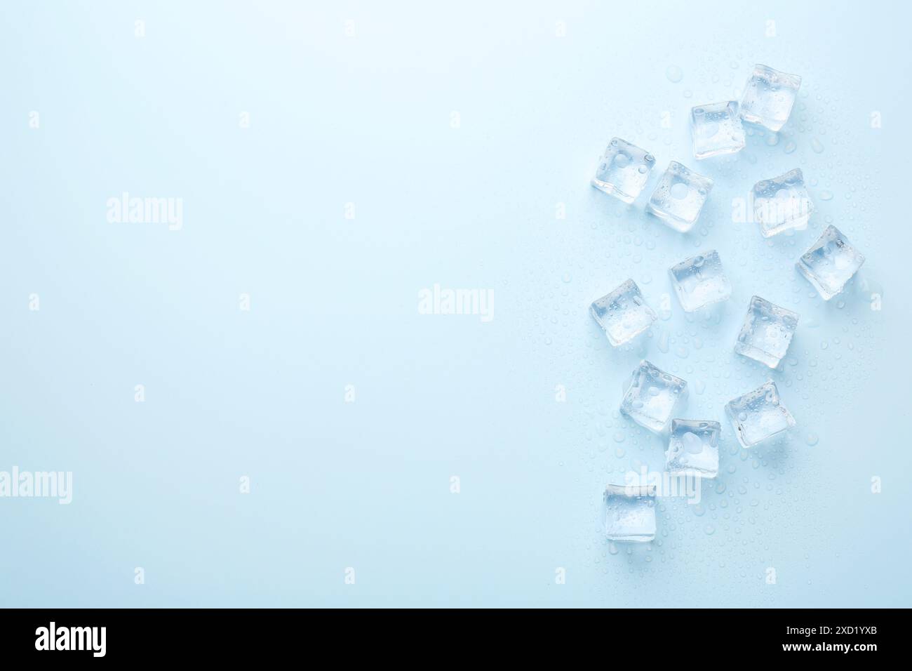 Crystal clear ice cubes on light blue background, flat lay. Space for text Stock Photo - Alamy