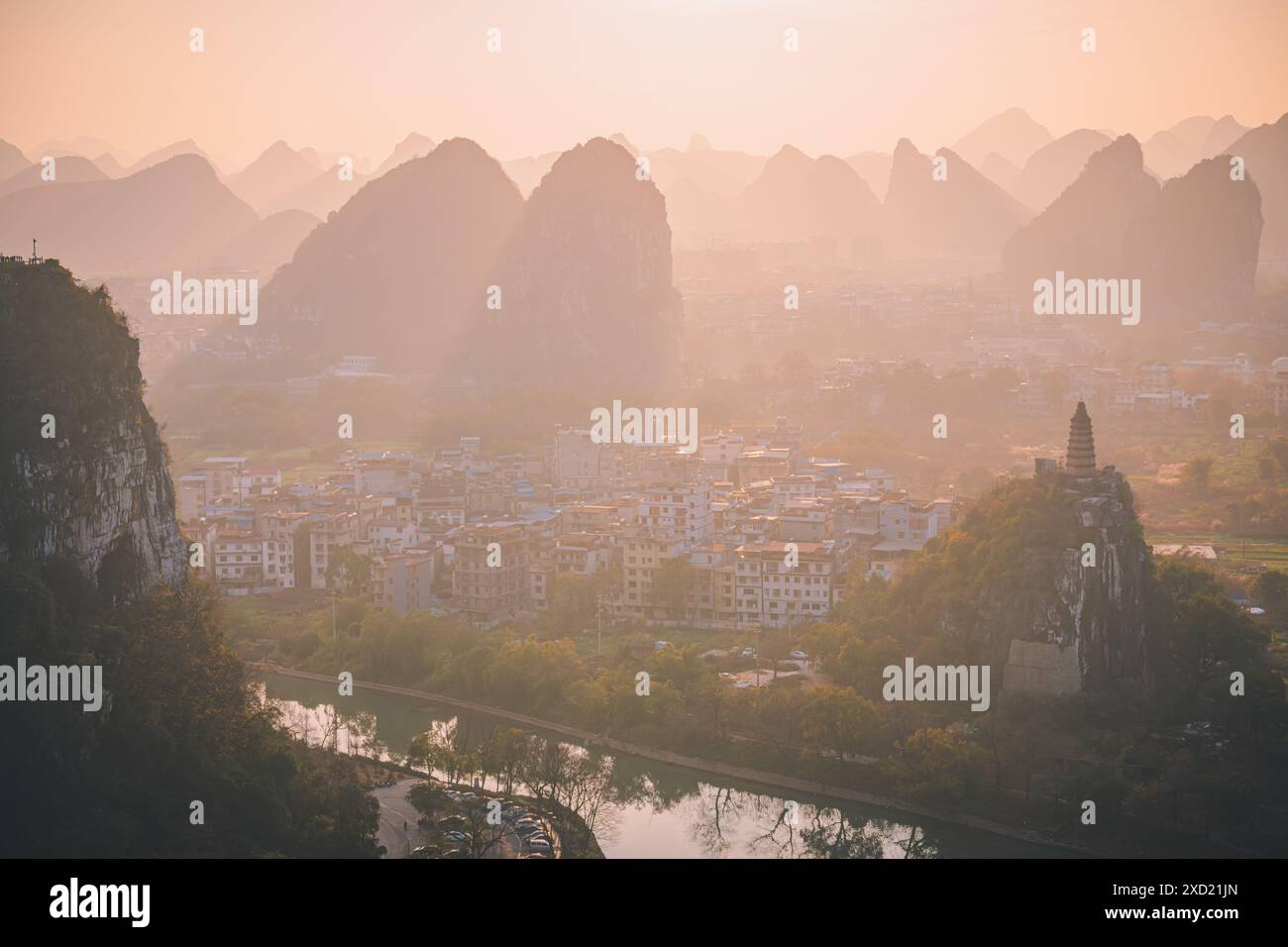 Limestone mountains at the sunset surrounded by the city buildings ...