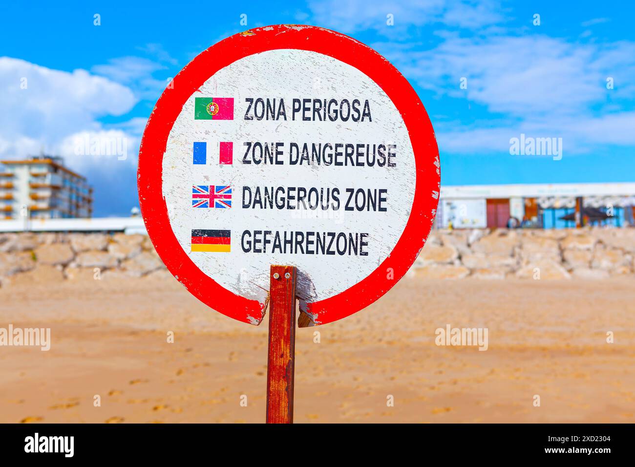 Sign indicating a dangerous zone at the beach. Sign on a pole ...