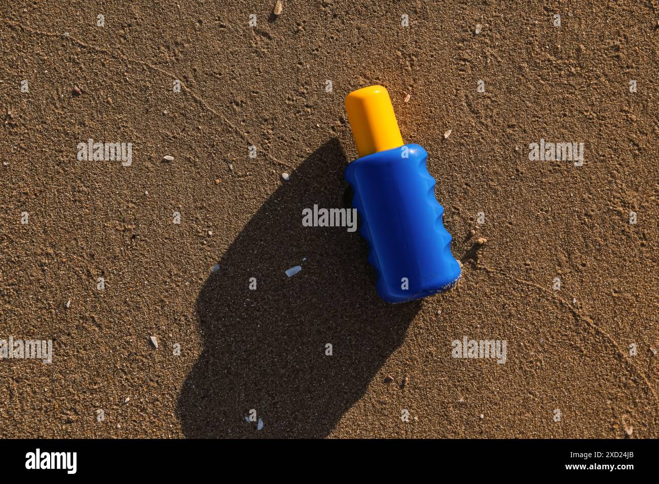 Bottle of sunscreen cream on sand at sea beach Stock Photo - Alamy