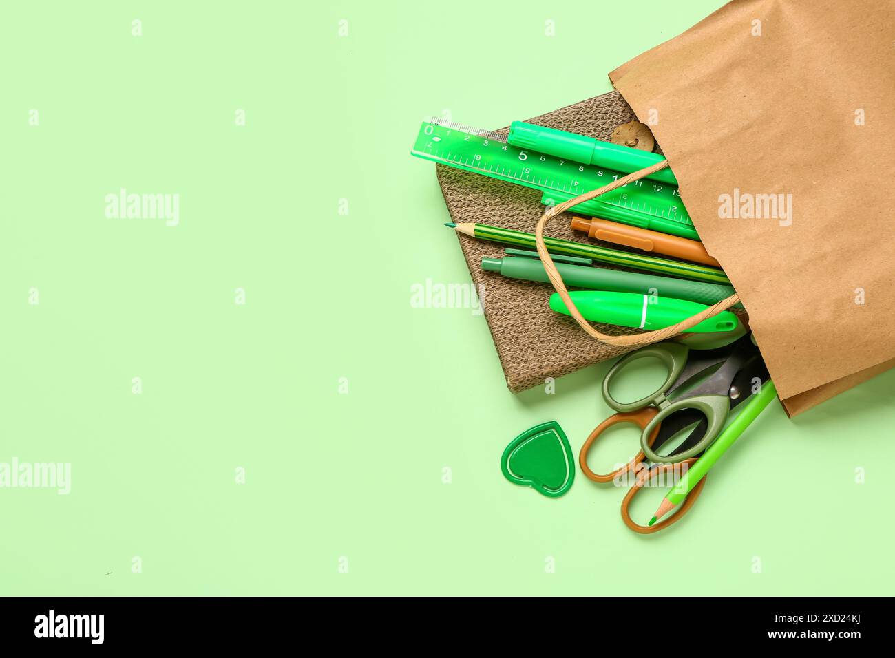 Shopping bag with school stationery on green background Stock Photo - Alamy